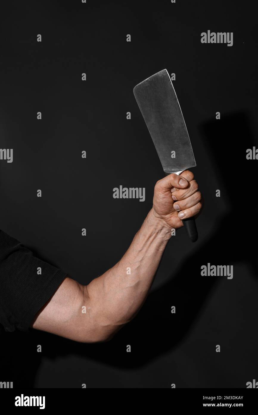 Man with meat cleaver on black background Stock Photo - Alamy