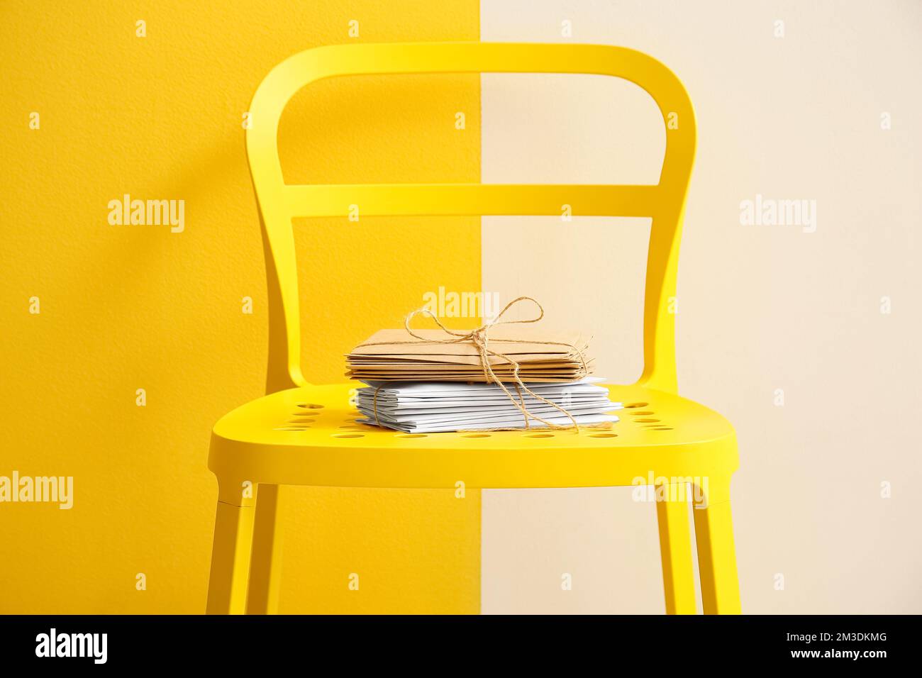 Stack of tied letters on chair near color wall. Mail concept Stock ...