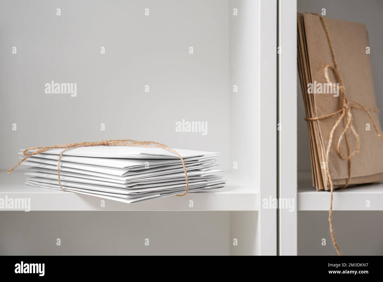 Tied letters on shelf unit, closeup. Mail concept Stock Photo - Alamy