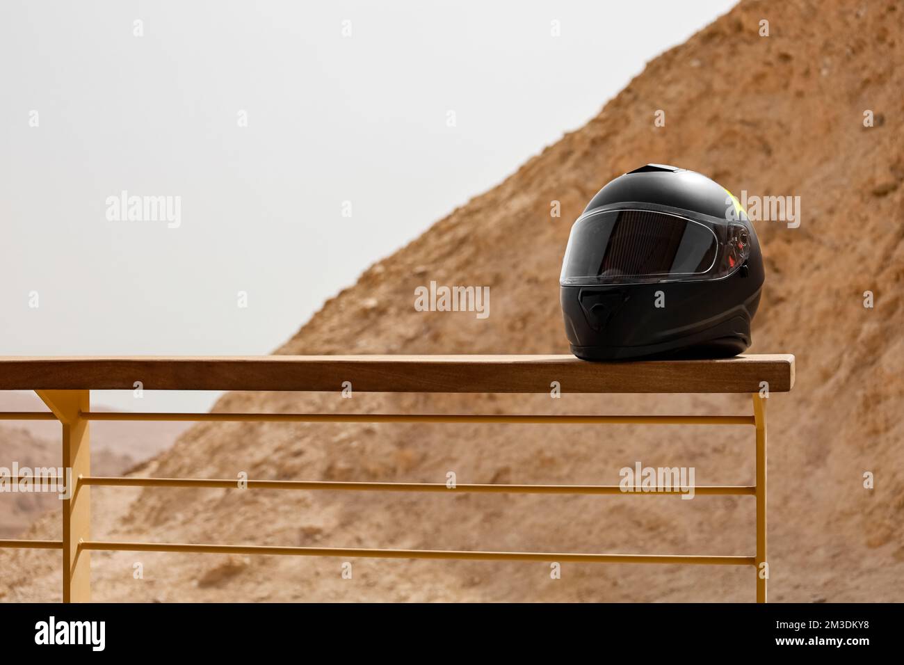 Motorcycle helmet on fence in desert Stock Photo - Alamy