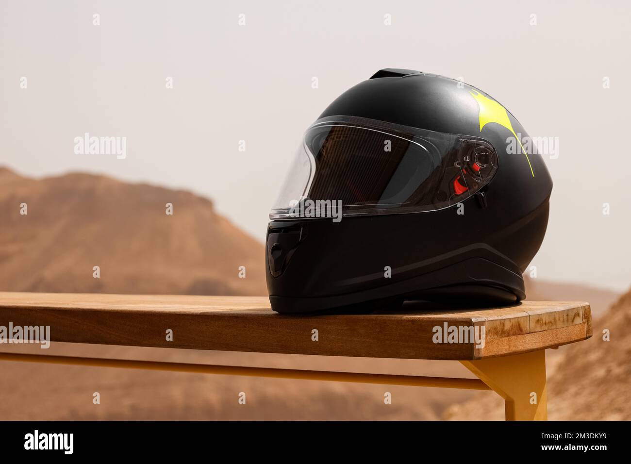 Motorcycle helmet on fence in desert Stock Photo - Alamy