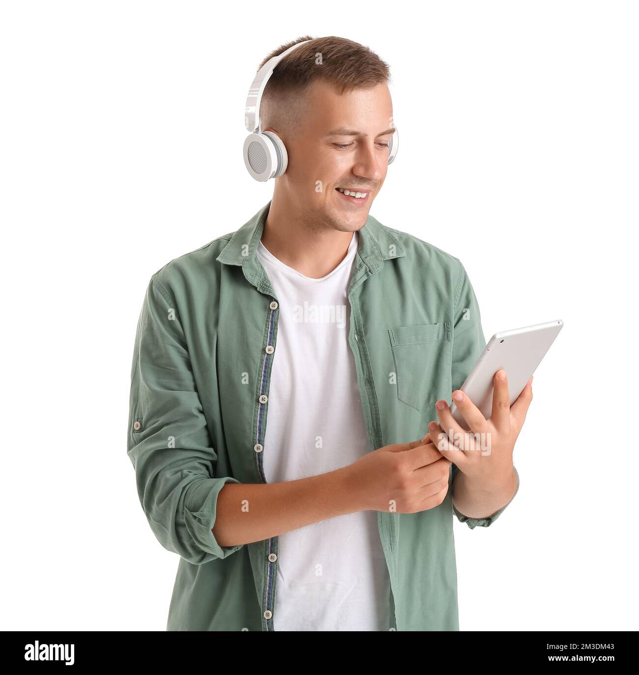Young man with headphones and tablet computer studying online on white ...