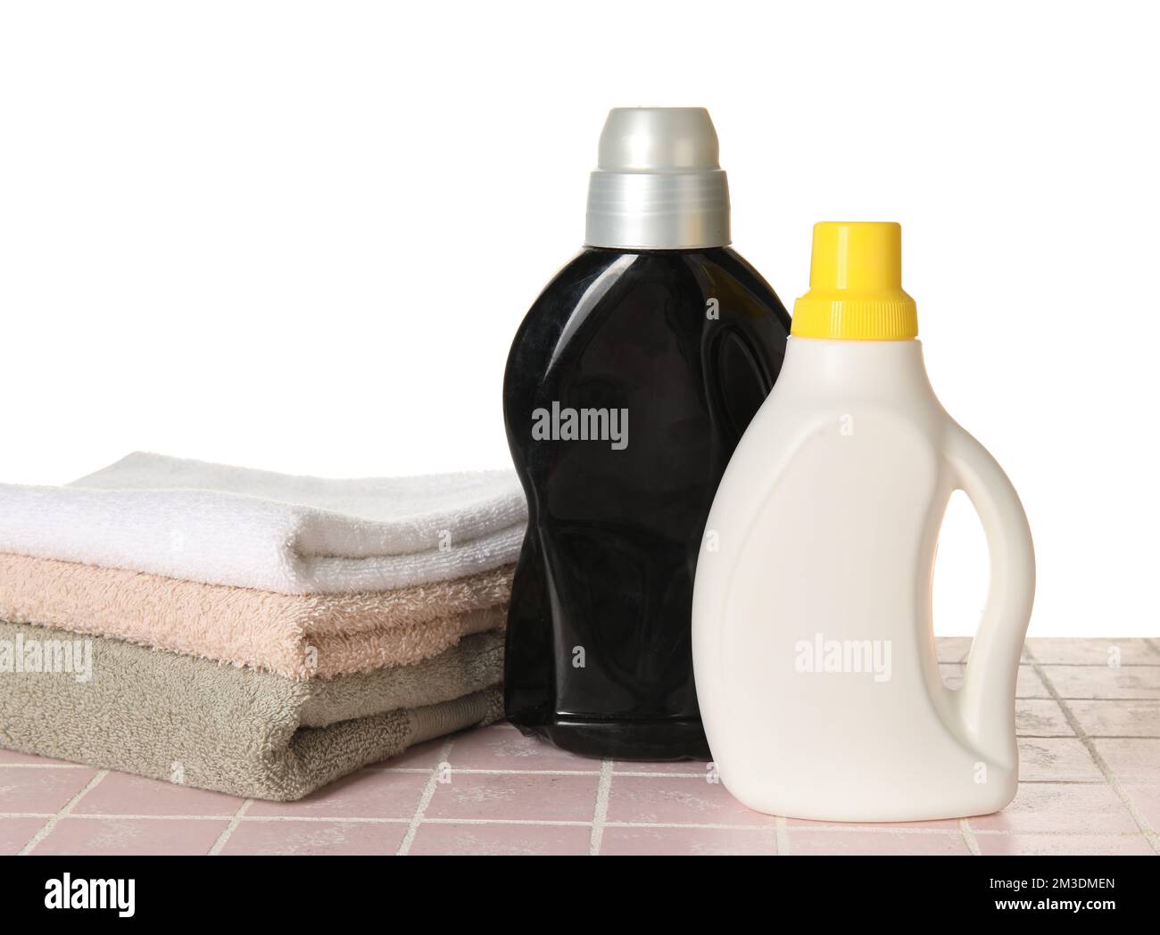 Laundry detergents and towels on table against white background Stock ...