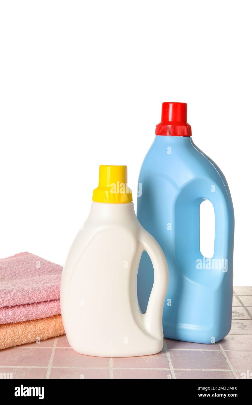 Laundry detergents and towels on table against white background Stock ...