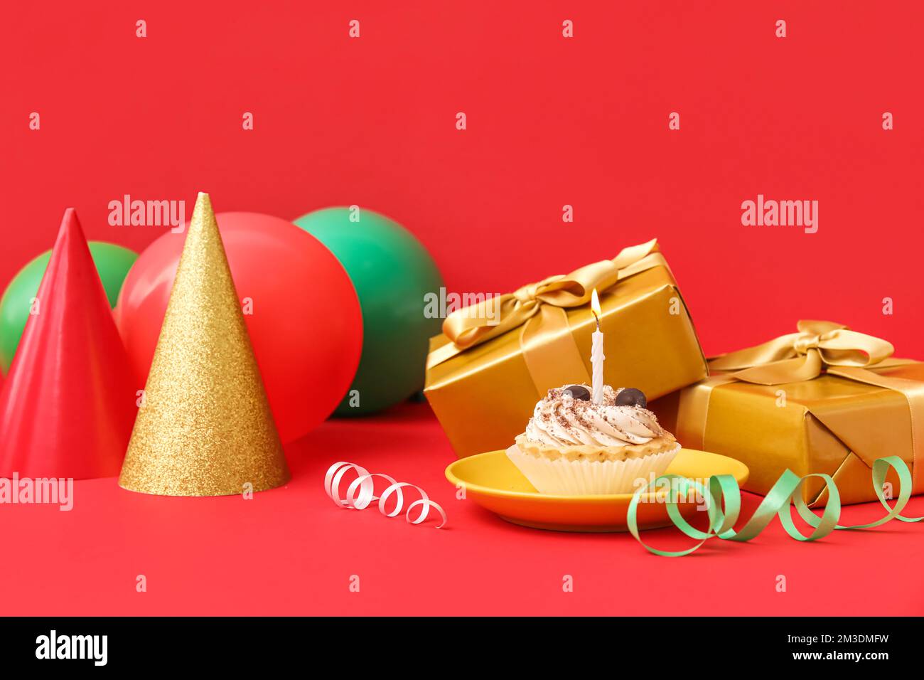 Birthday cake, party hats, gifts and balloons on red background Stock ...