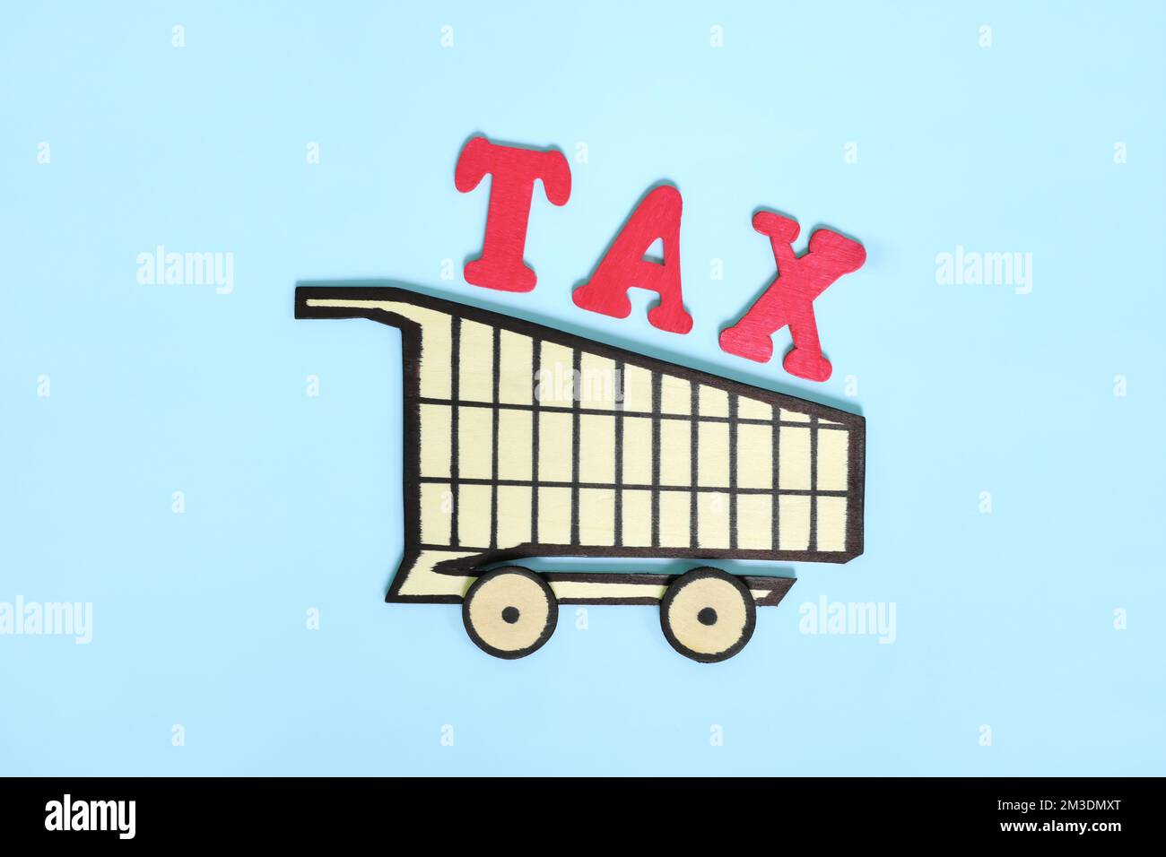 Shopping, sales and consumer tax concept. Wooden shopping cart with ...