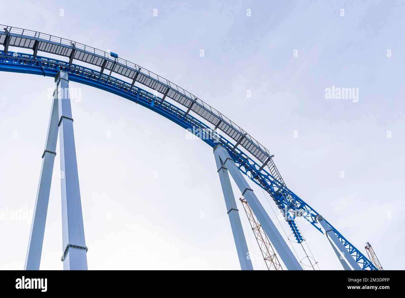 Part of a blue rollercoaster in amusement park over cloudy sky Stock Photo - Alamy