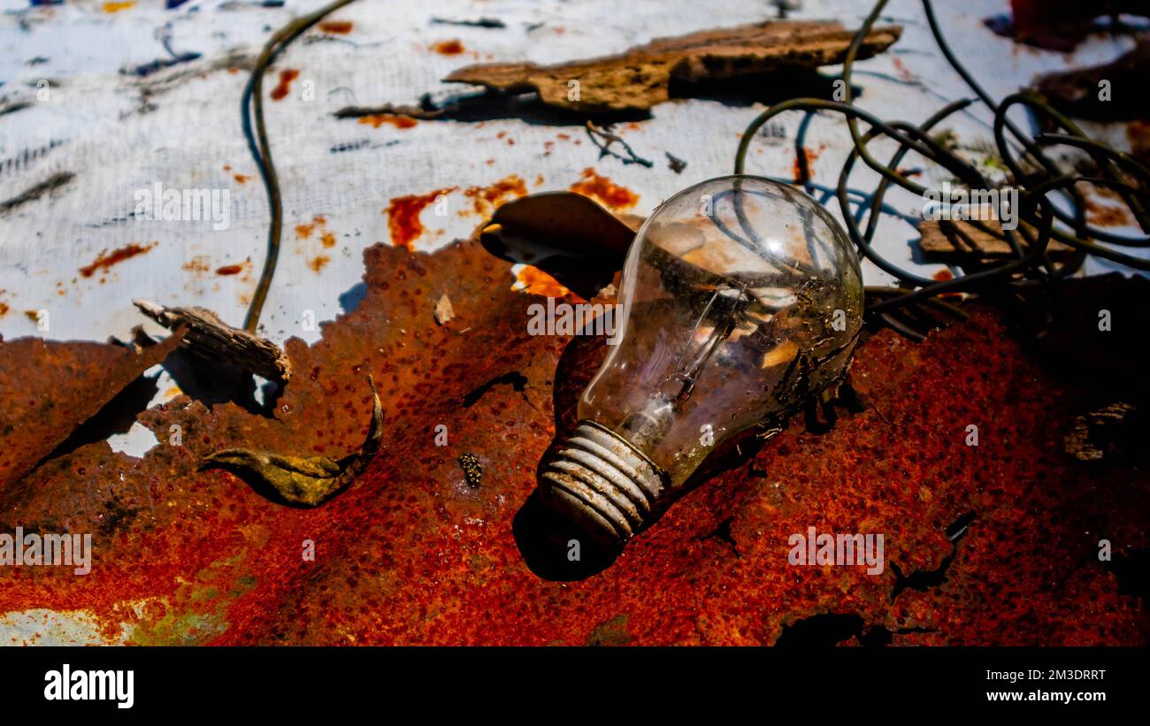 Light bulb on rusty zinc as background Stock Photo - Alamy