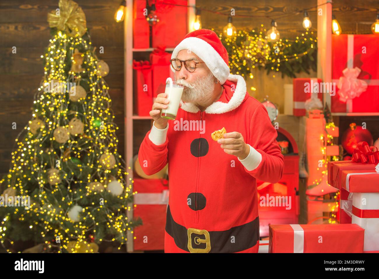 Santa Claus takes a cookie on Christmas Eve as a thank you gift for ...