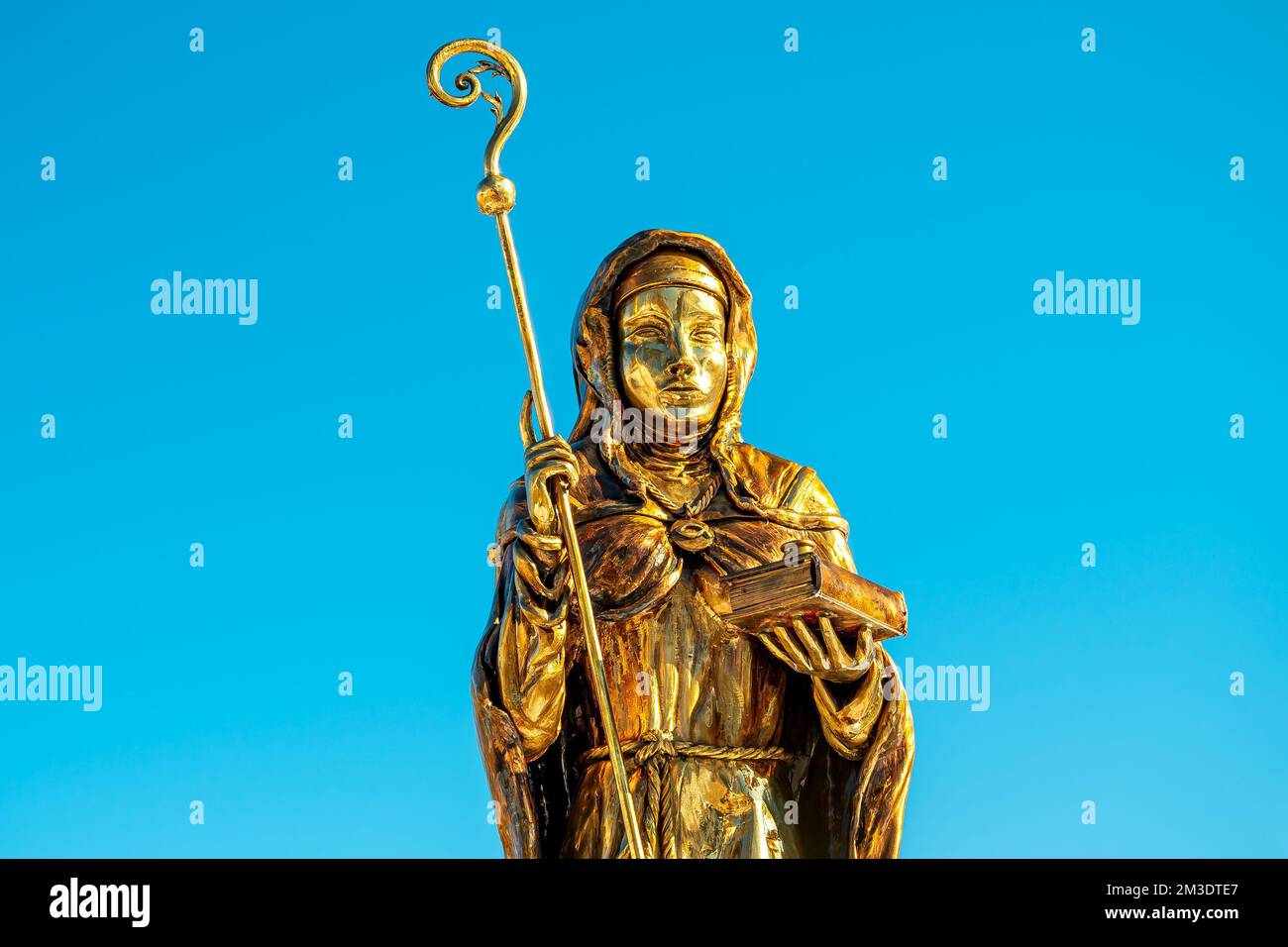 The golden statue of Saint Walpurga before a blue background - Anglo ...