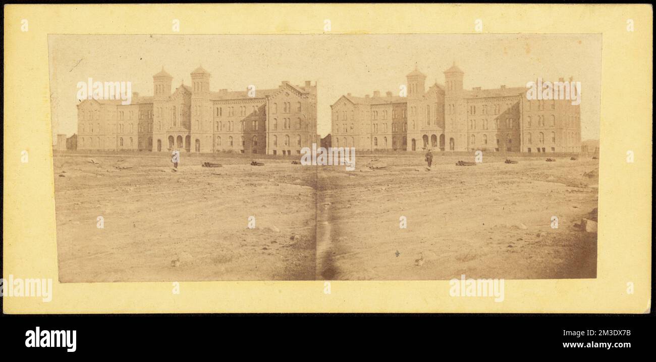Large unidentified building with excavation and pipes in the foreground ...