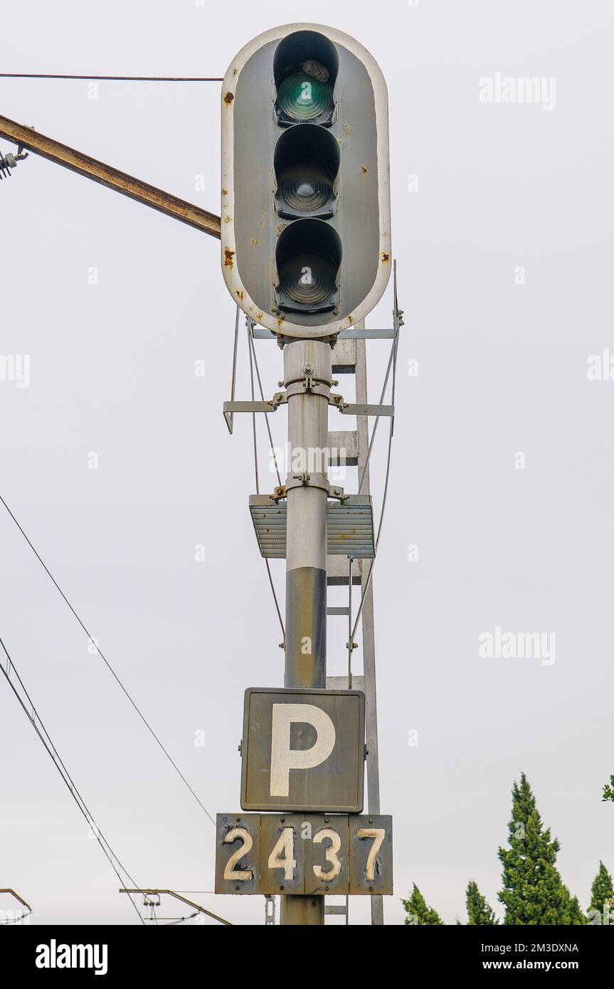 A vertical low-angle view of the traffic light column with an old ...