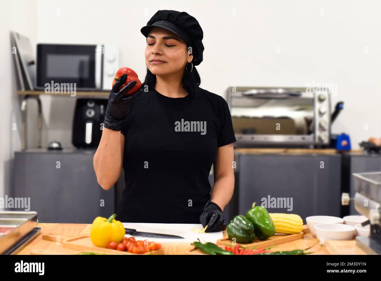Mexican woman laughing during cooking tacos in the kitchen Stock Photo ...