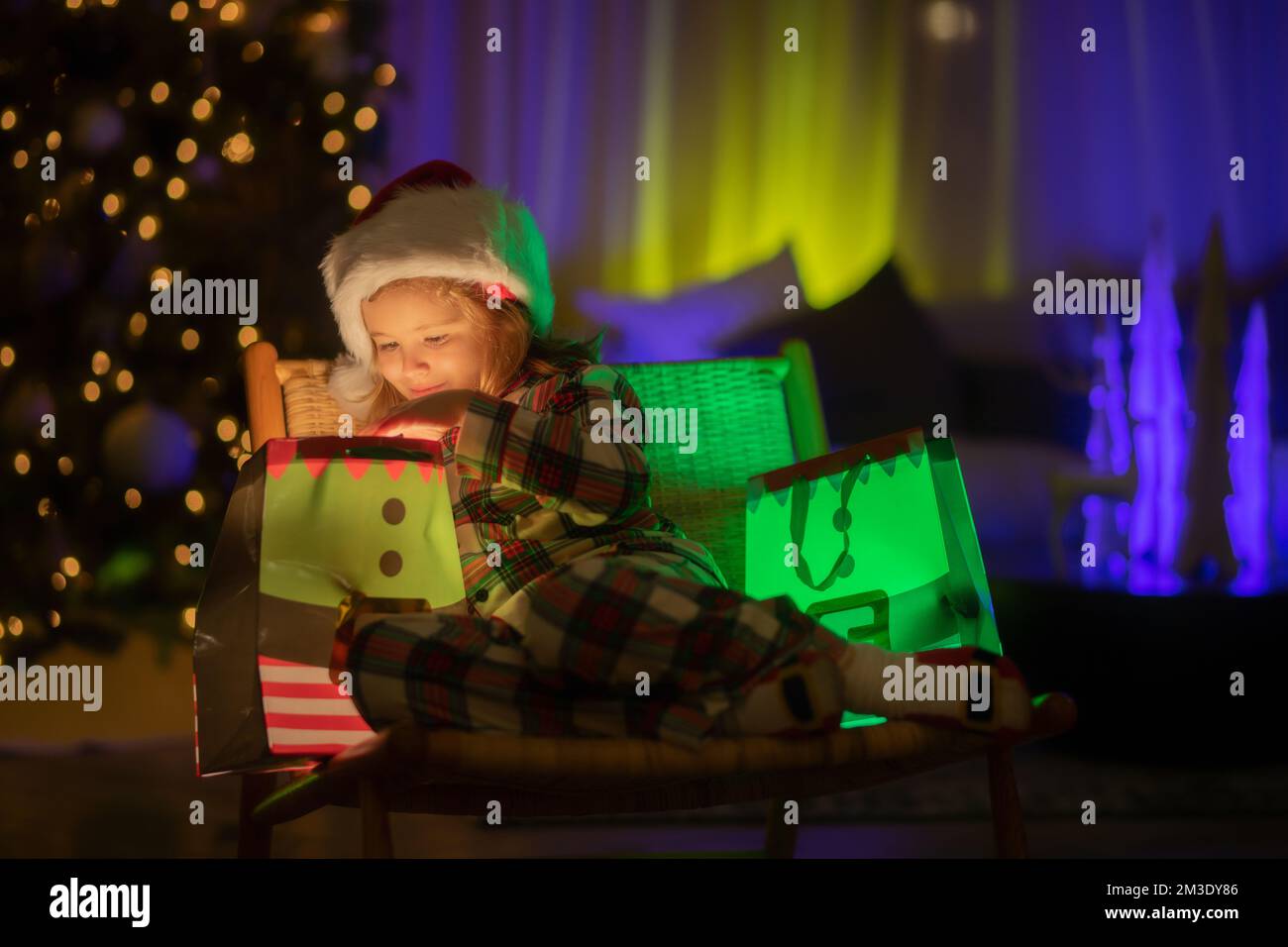 Kid with present gift with magic light. Lighting present gift bag ...