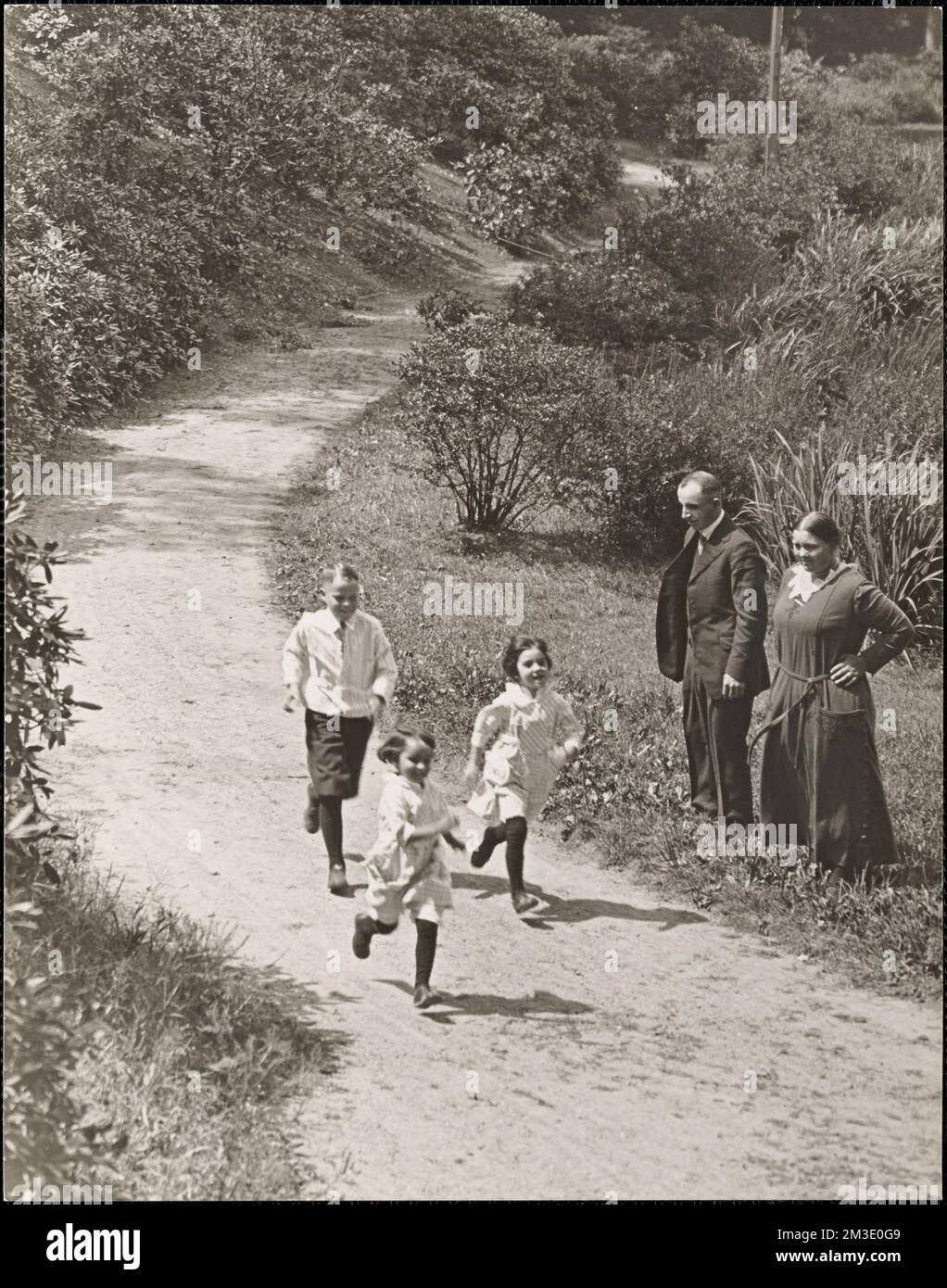 Leon and Alma watch Herman, Lillian, and Marian Abdalian run along a ...