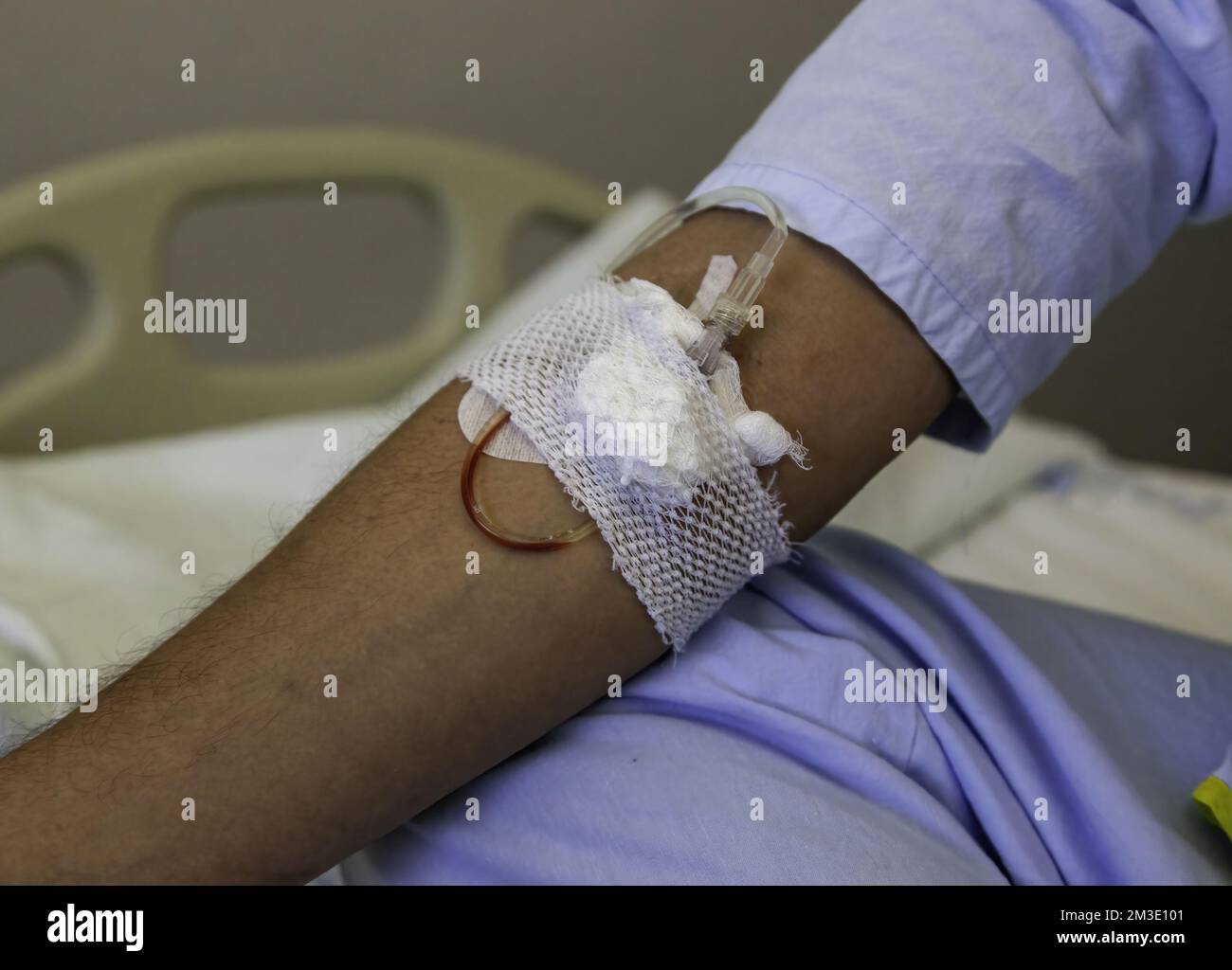 Ill man with injection in one hand to administer medication Stock Photo ...