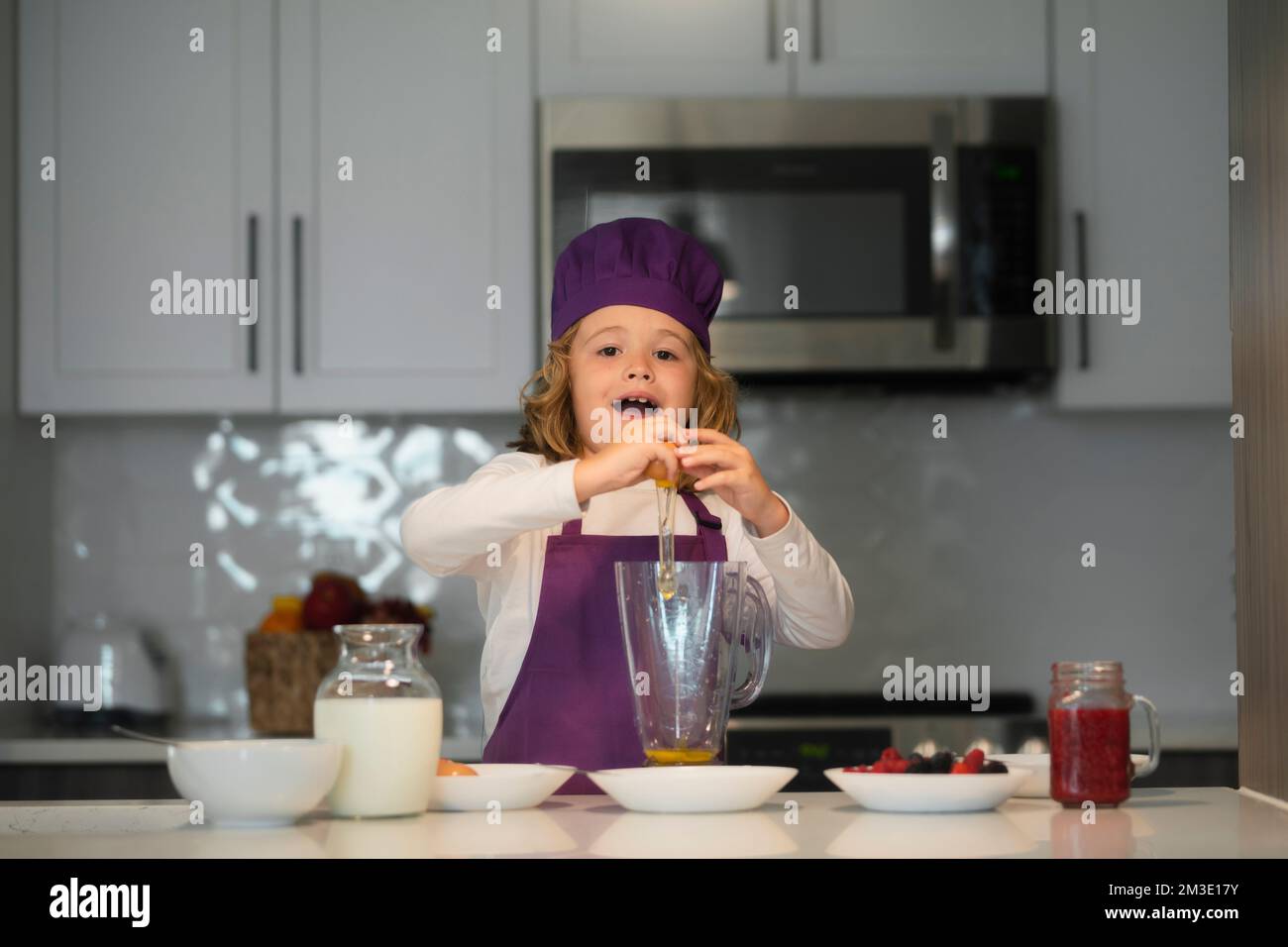 Cooking in kitchen. Chef cook child having fun preparing a cake in ...