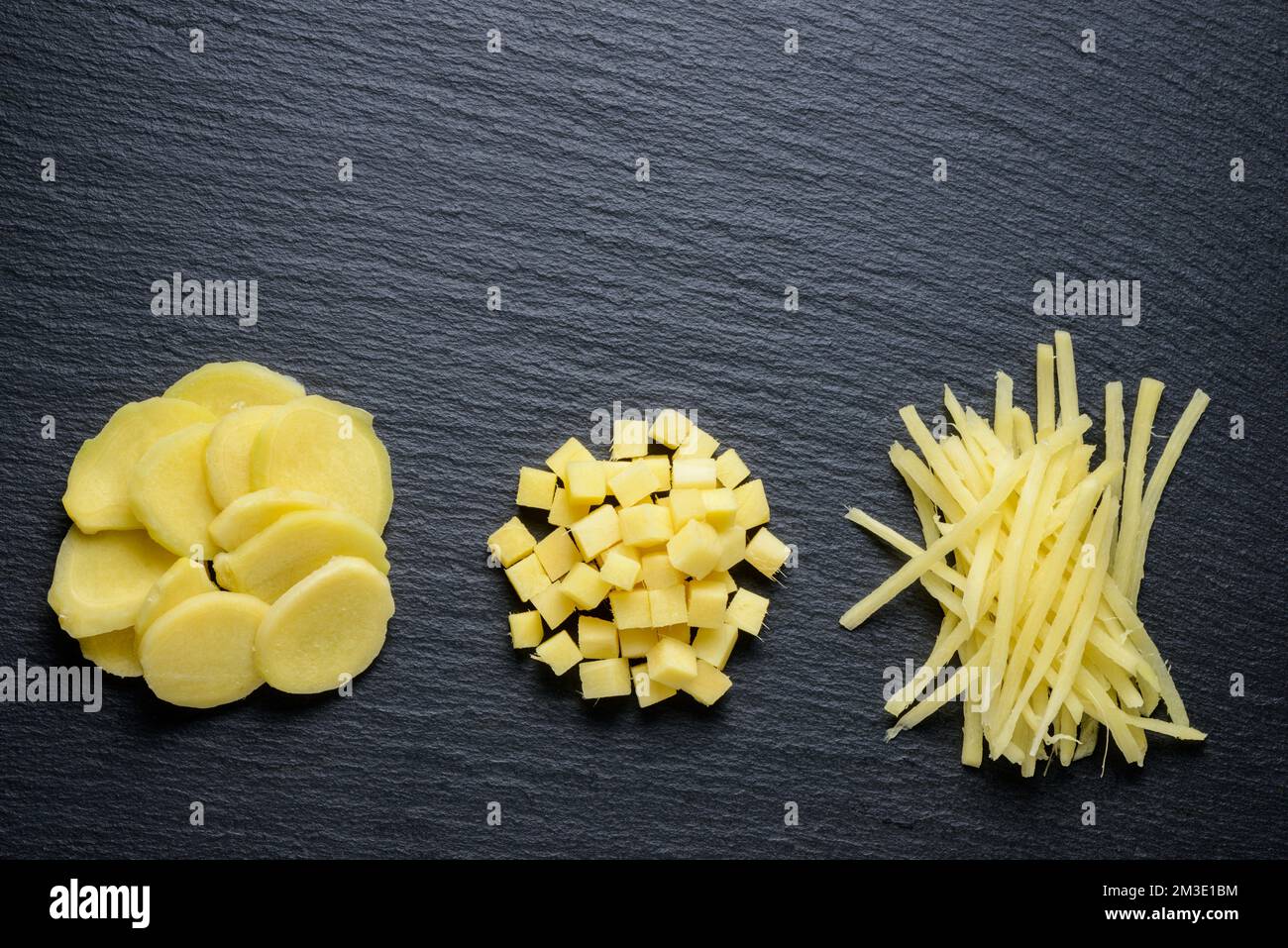top view of piles vegetables roots of ginger chopped stripes, crushed ...