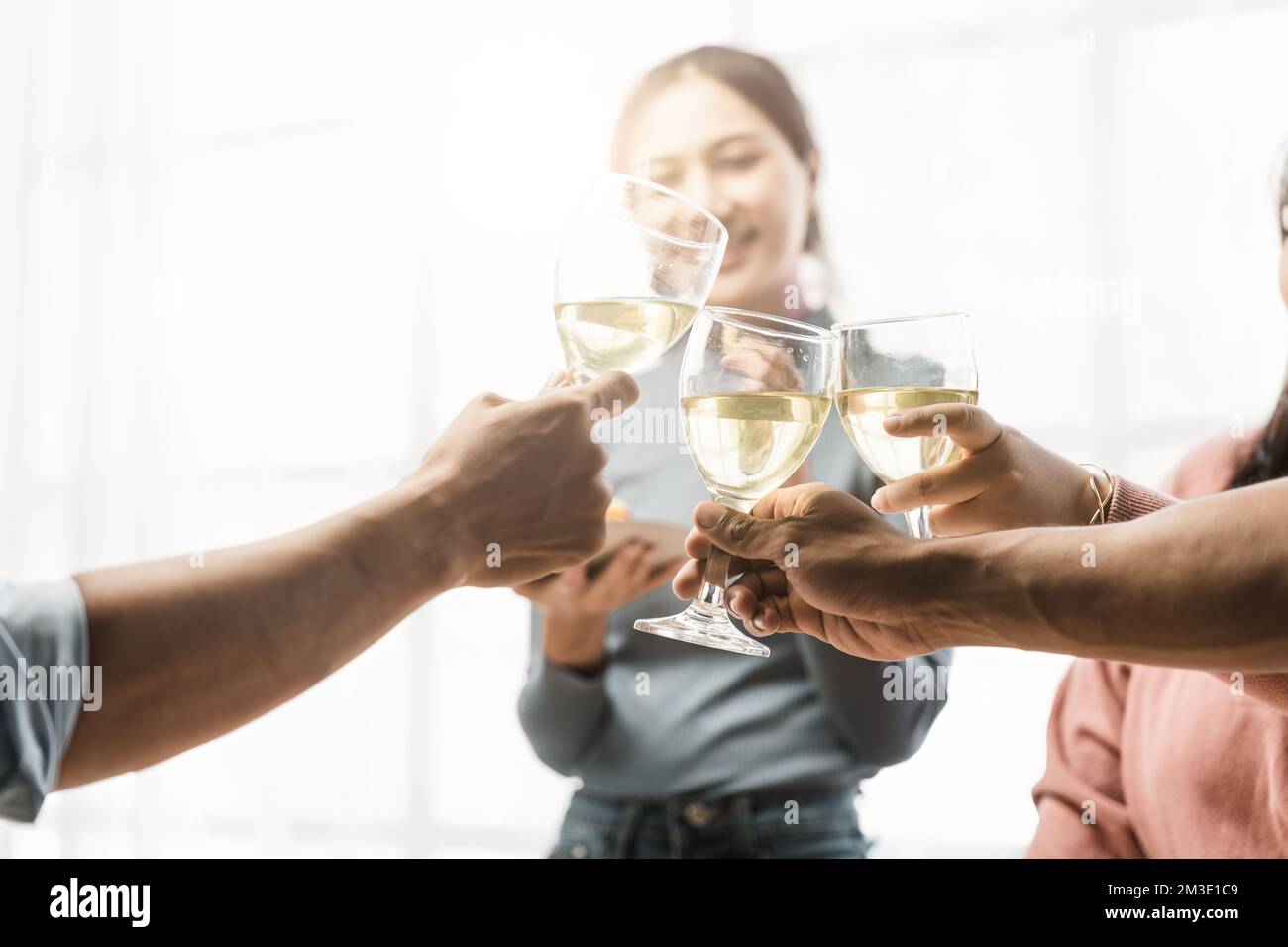 Group of happy colleagues having fun at a new year celebration or ...