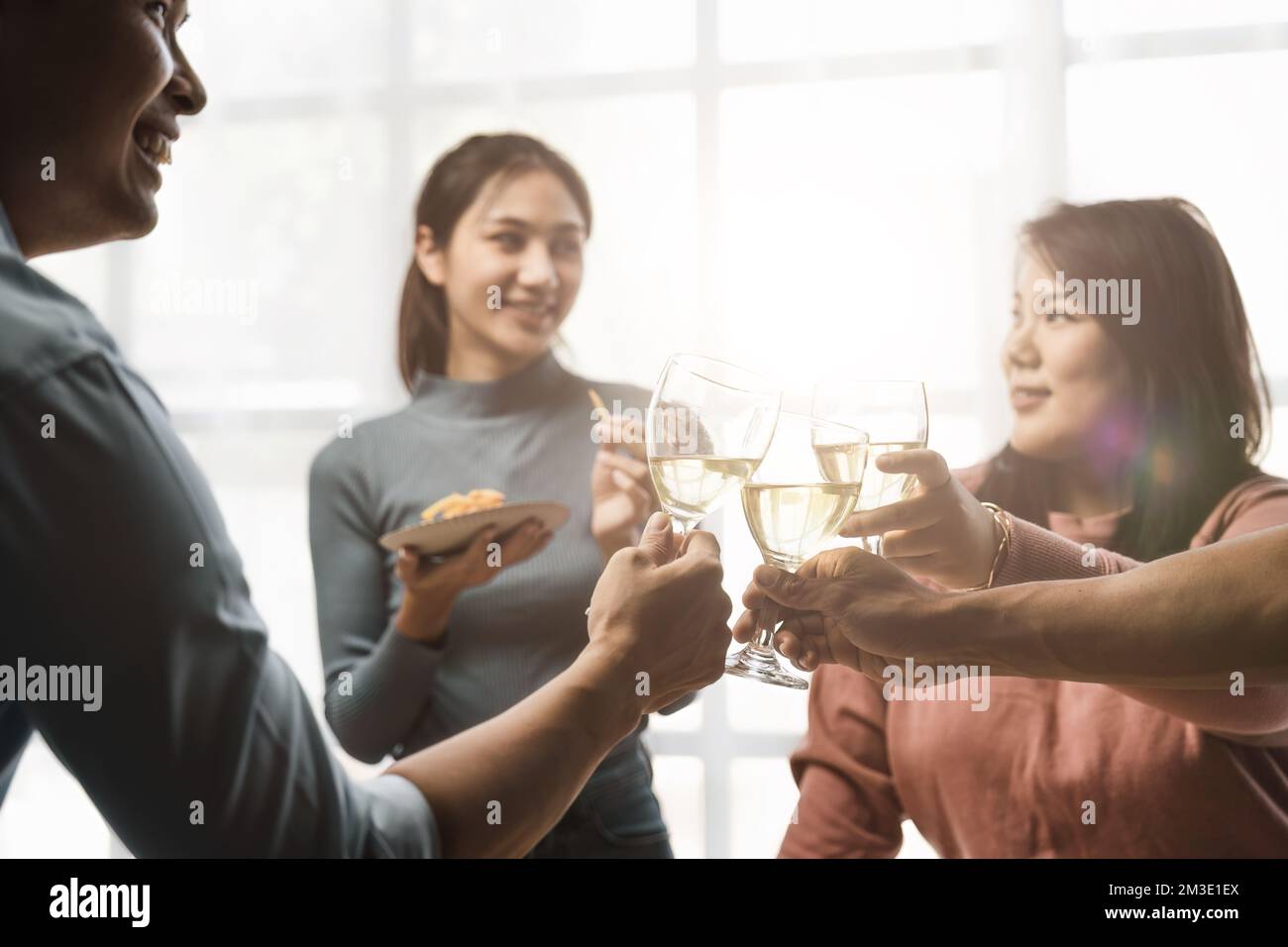 Group of happy colleagues having fun at a new year celebration or business success. Coworkers ...