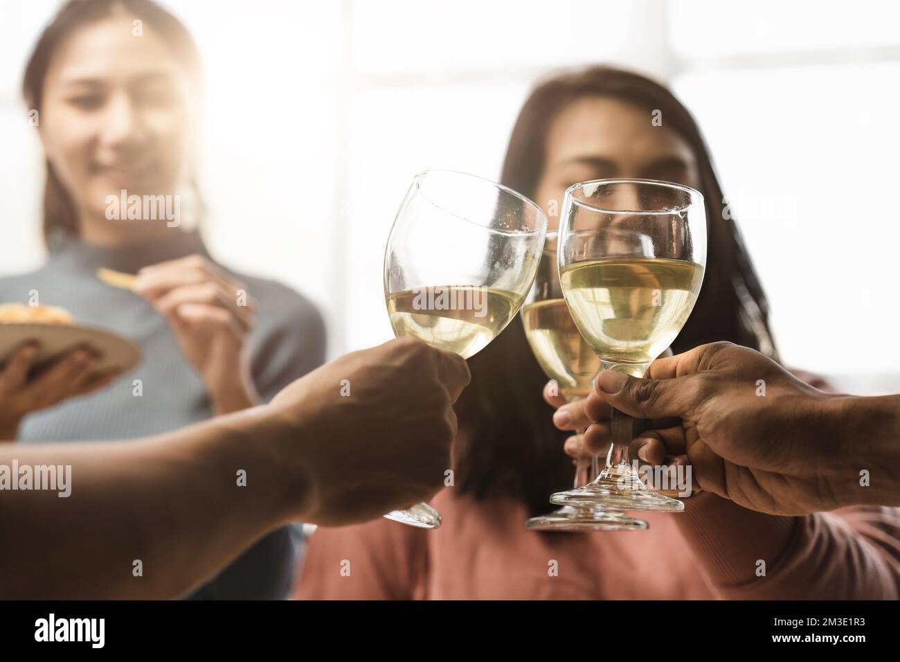 Group of happy colleagues having fun at a new year celebration or ...