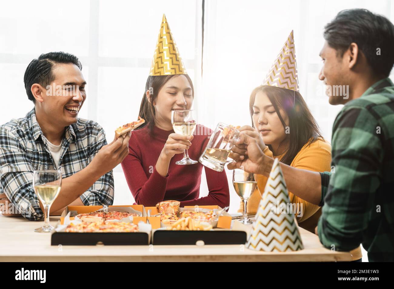Group of diverse Asian friends gather to celebrate Christmas with ...