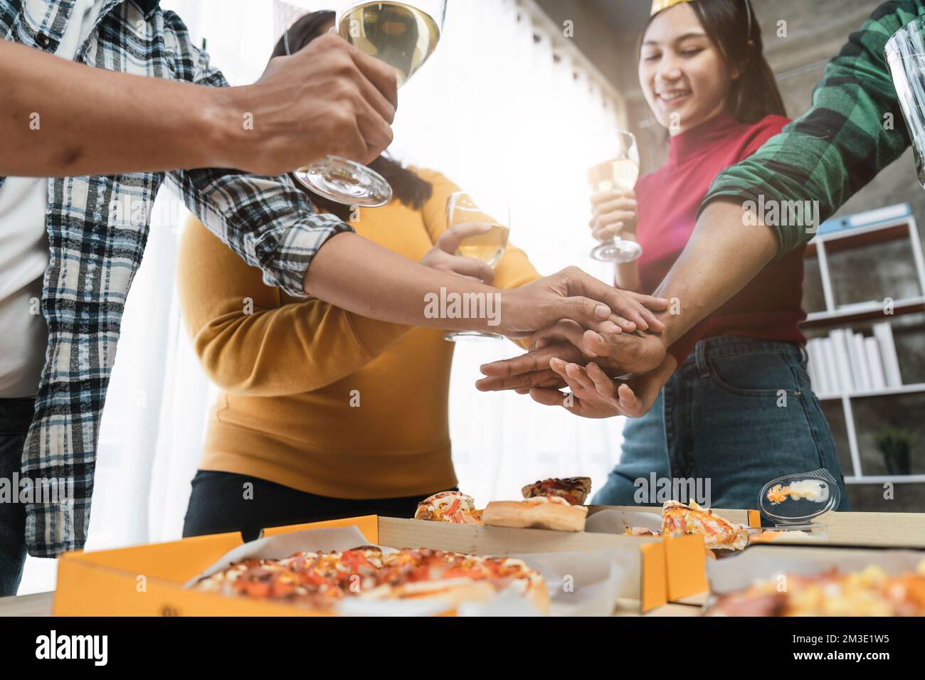 Group of happy colleagues having fun at a new year celebration or business success. Coworkers ...
