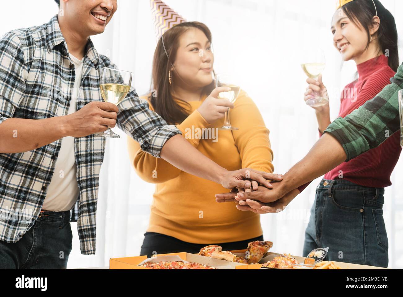 Group of happy colleagues having fun at a new year celebration or ...
