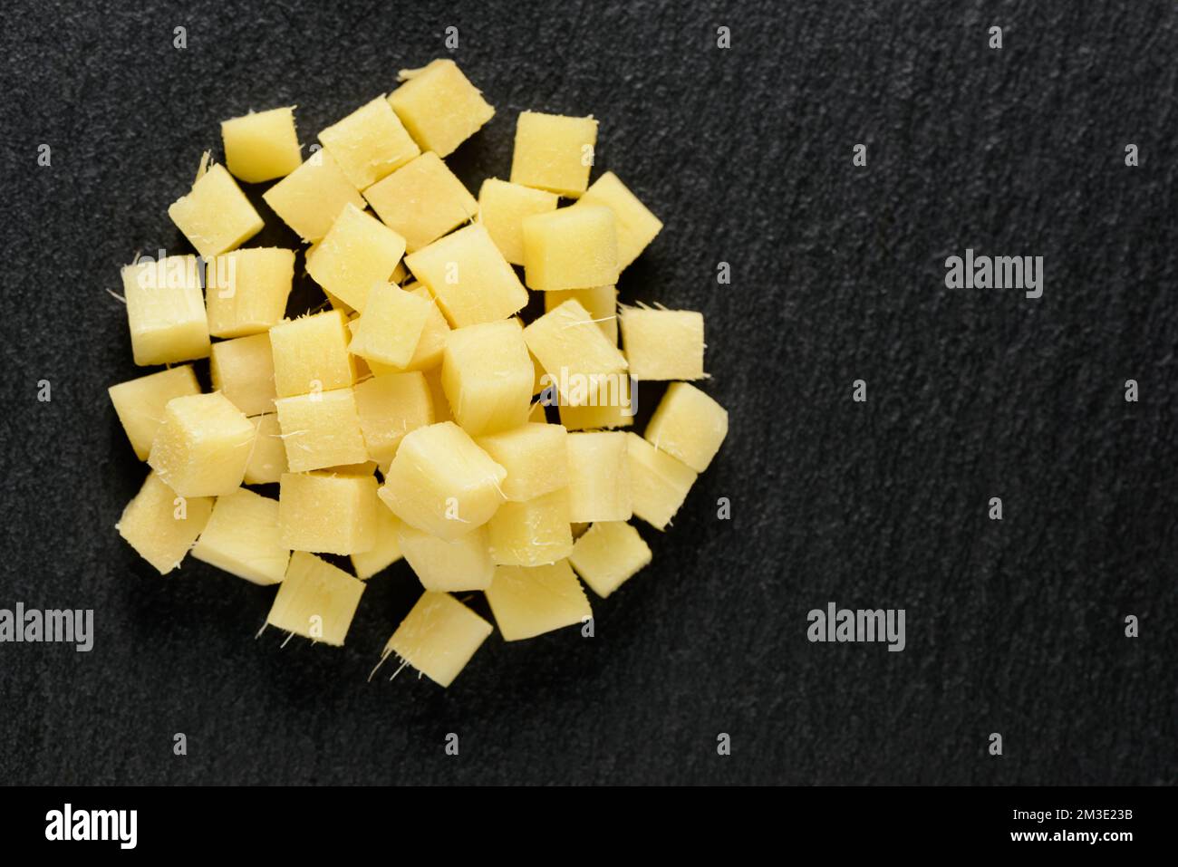 top view of diced fresh vegetables roots of ginger on black slate stone ...