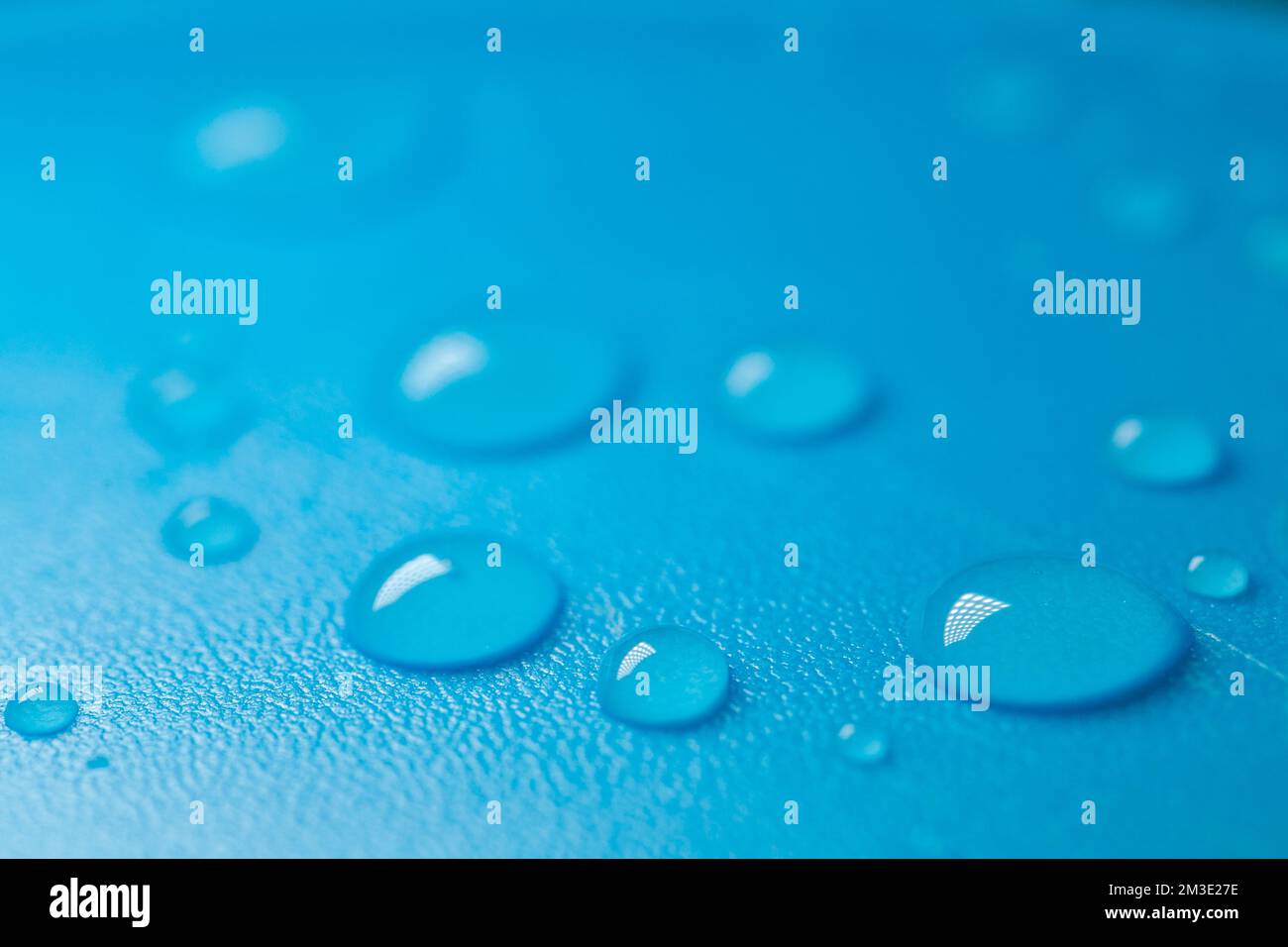 water drops on a blue background .Fluid texture in cold blue tones ...