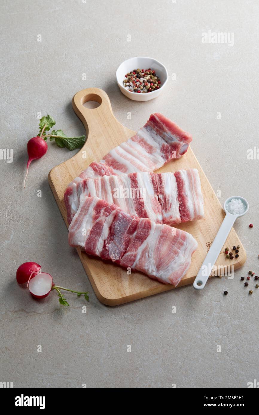 fresh pork on the cutting plate with gray background and many ...