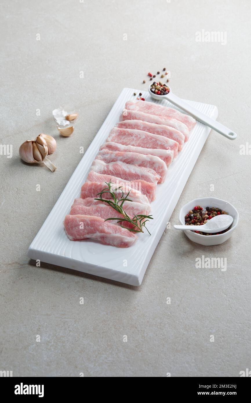 fresh pork on the cutting plate with gray background and many ...