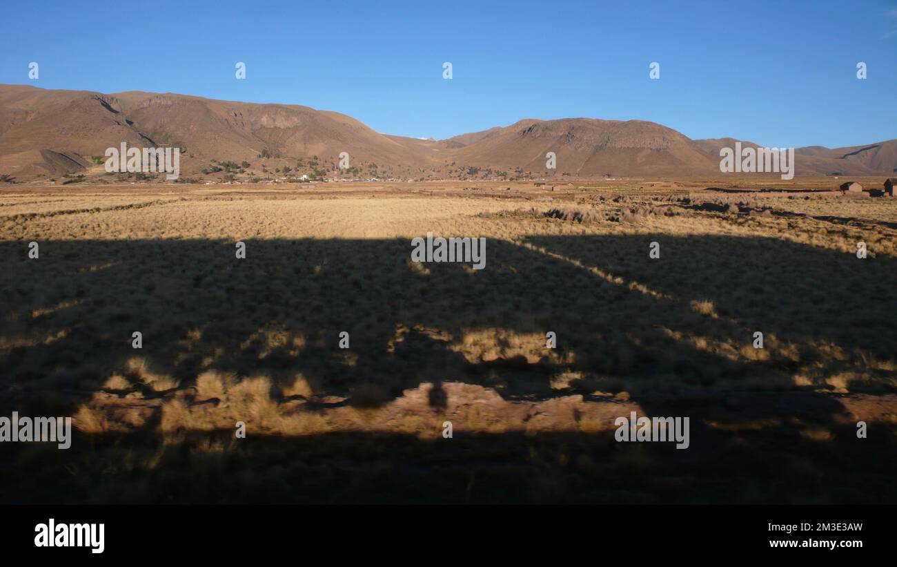Shadow of a driving Train in Desert blue sky mountains Stock Photo - Alamy