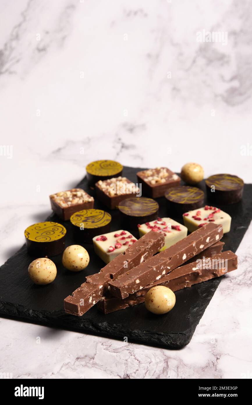 a variety of chocolates on a light background Stock Photo - Alamy