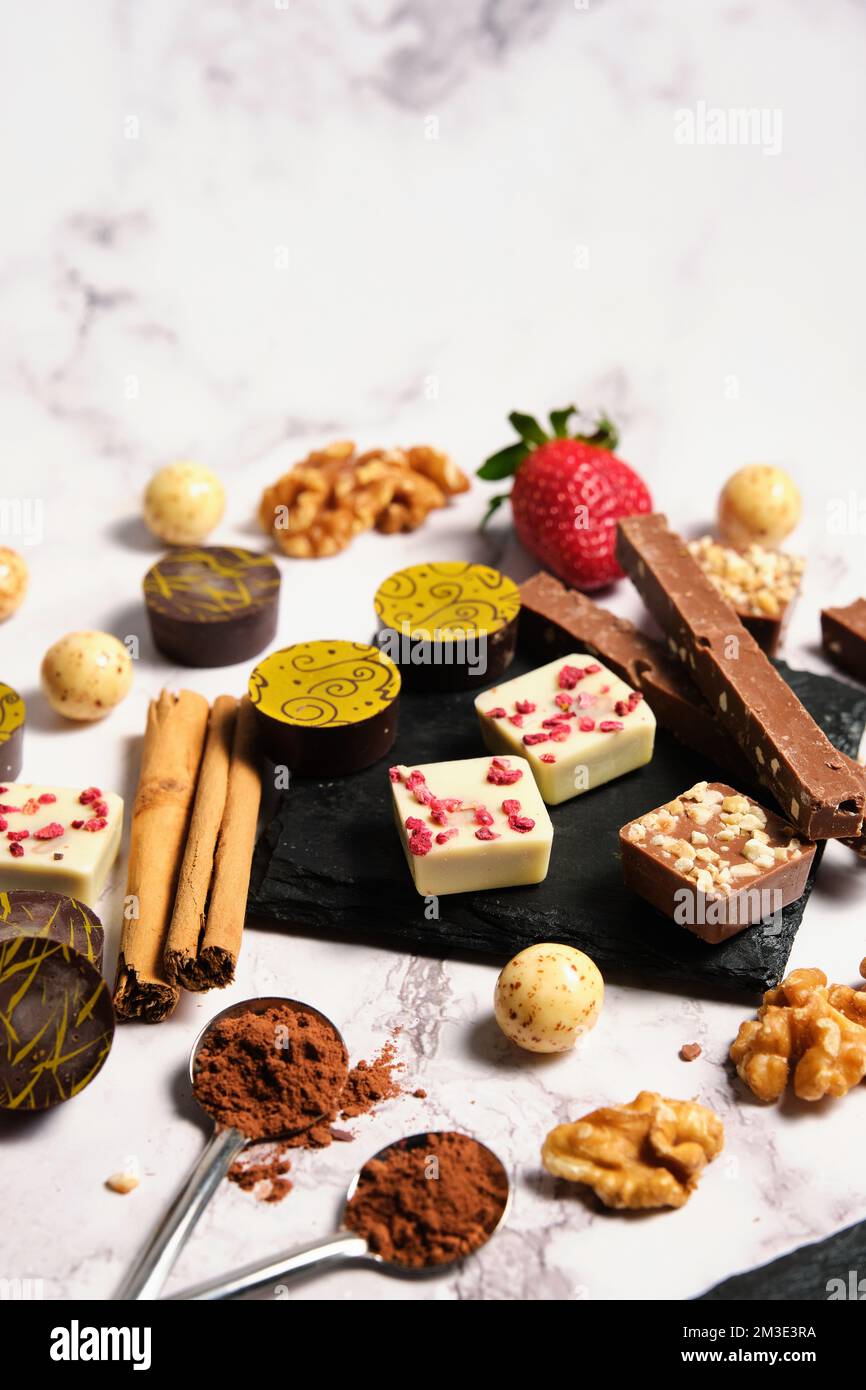a variety of chocolates on a light background Stock Photo - Alamy