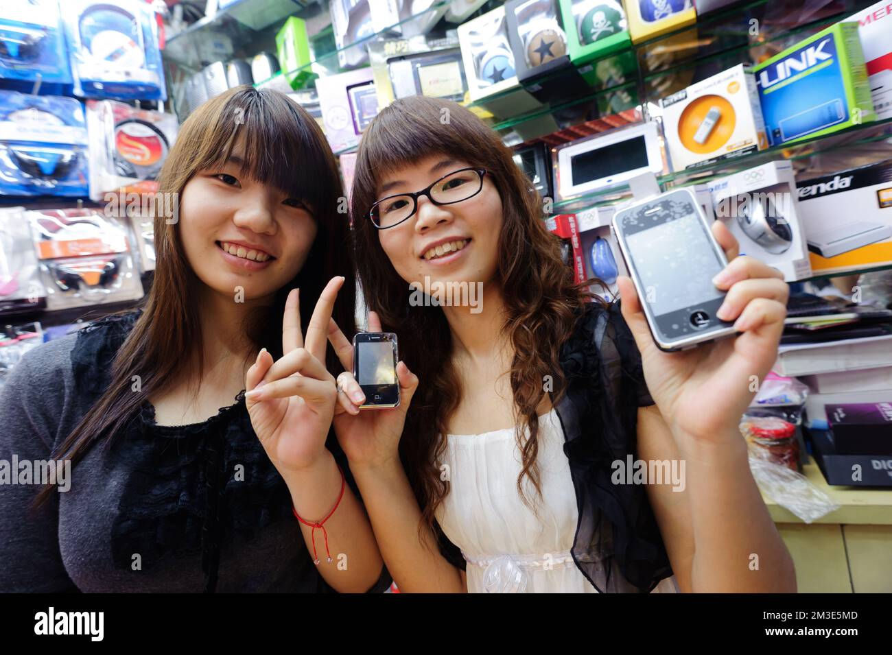Using phones hand china hi-res stock photography and images - Alamy