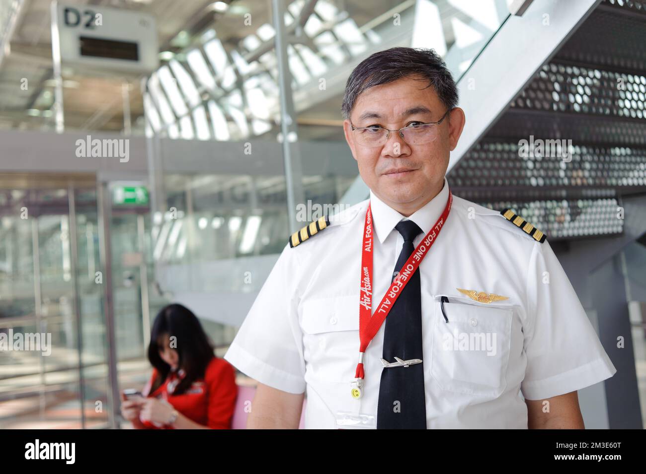 BANGKOK - OCT 27: Airasia pilot posing in Bangkok Airport on October 27 ...