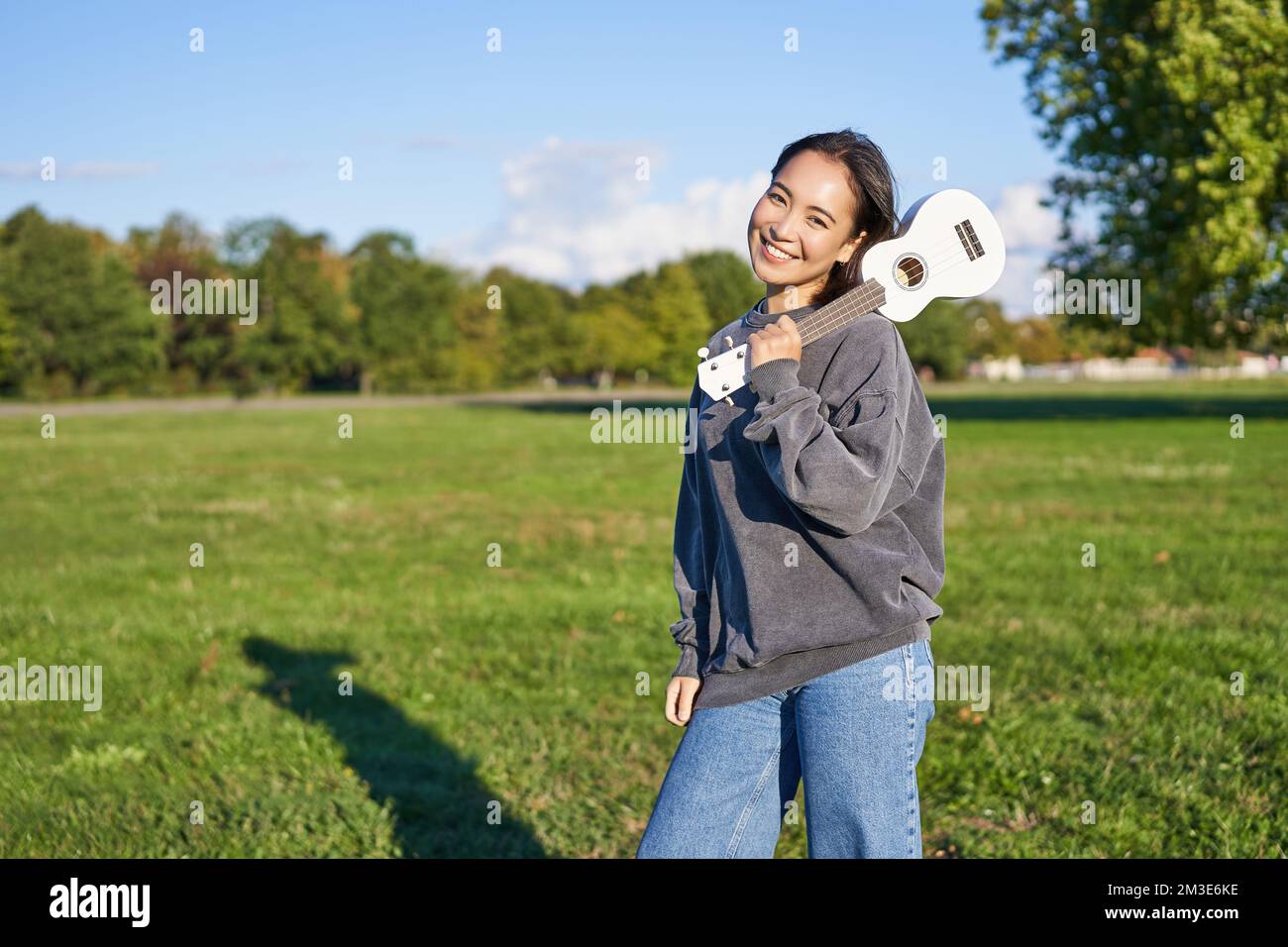 Beautiful korean girl posing with ukulele, young musician playing ...