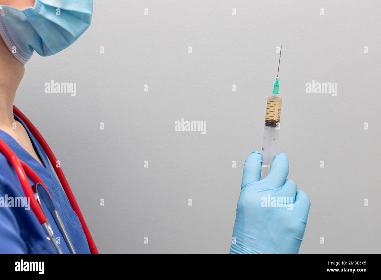 doctor holding a syringe with a needle. doctor holding a syringe ...