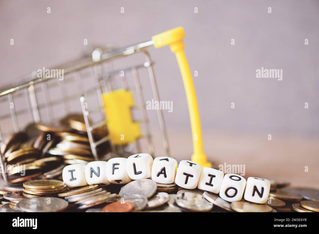 inflation with coin and shopping cart on wooden background, business ...