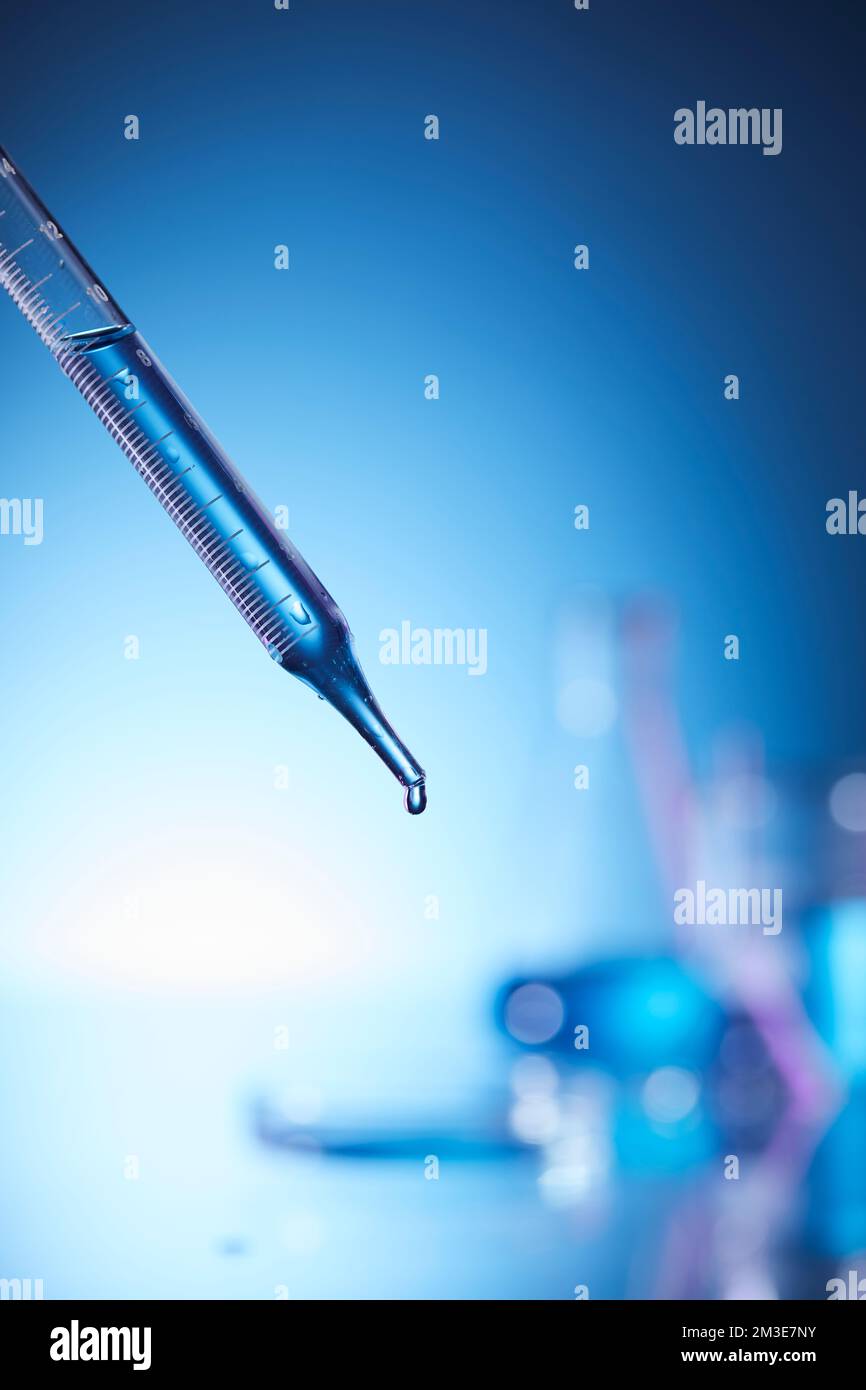 science lab with clear blue background and test tubes with blue ...