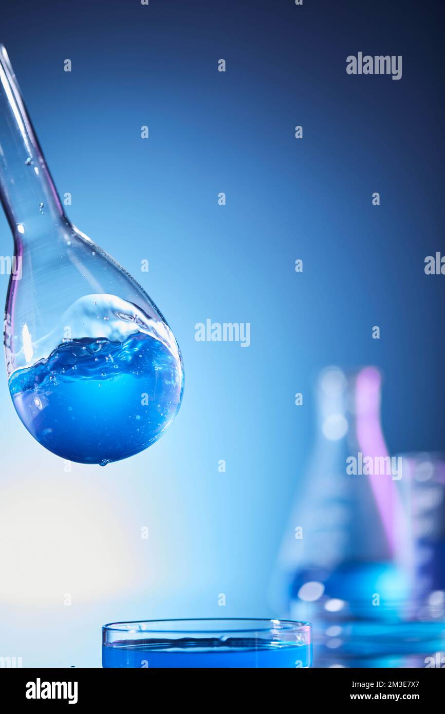 science lab with clear blue background and test tubes with blue ...
