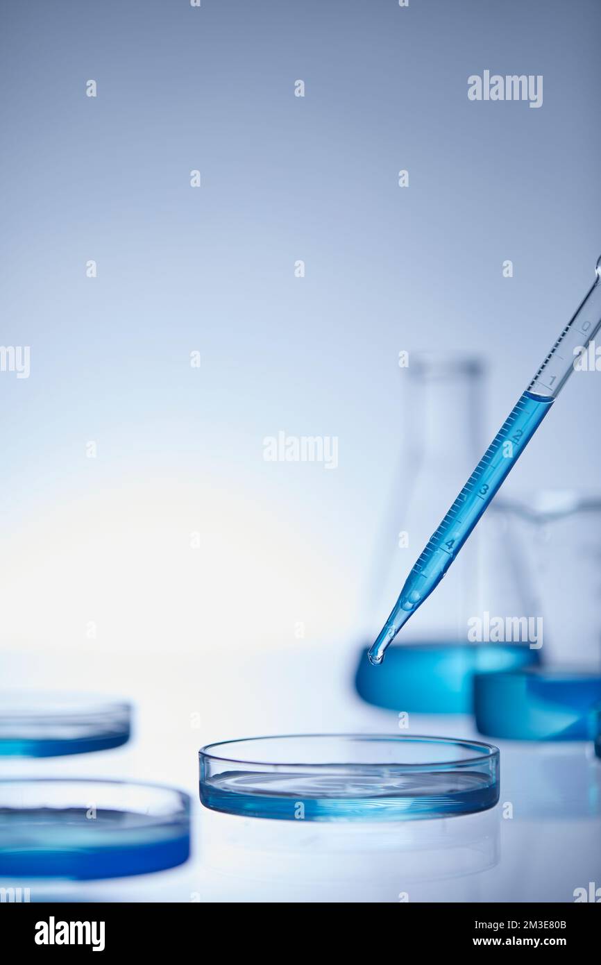 science lab with clear blue background and test tubes with blue ...