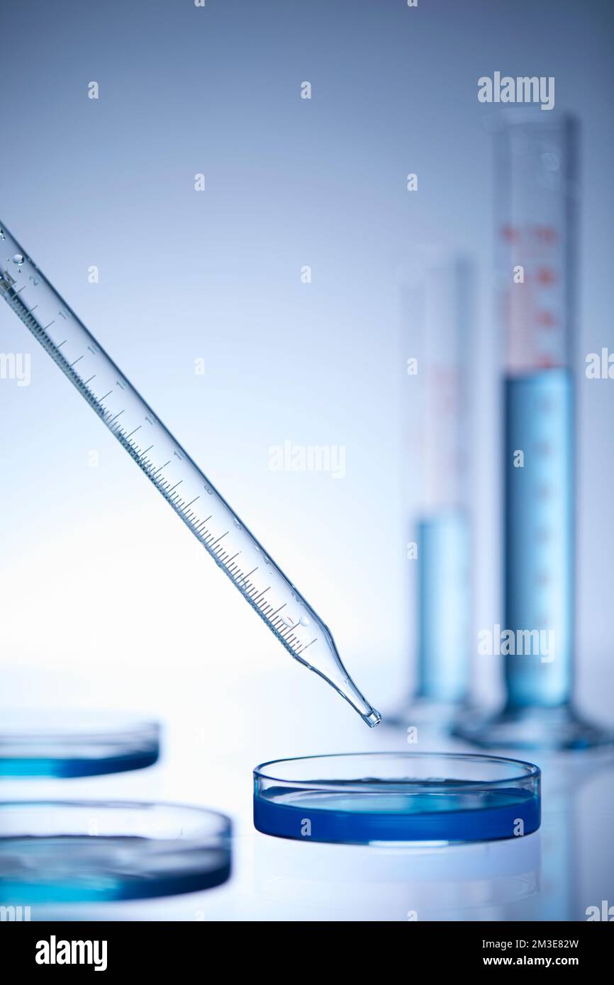 science lab with clear blue background and test tubes with blue ...