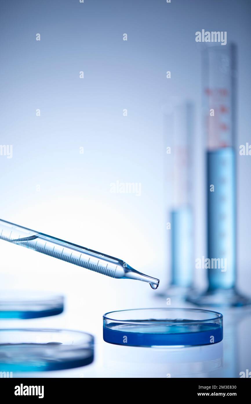 science lab with clear blue background and test tubes with blue ...