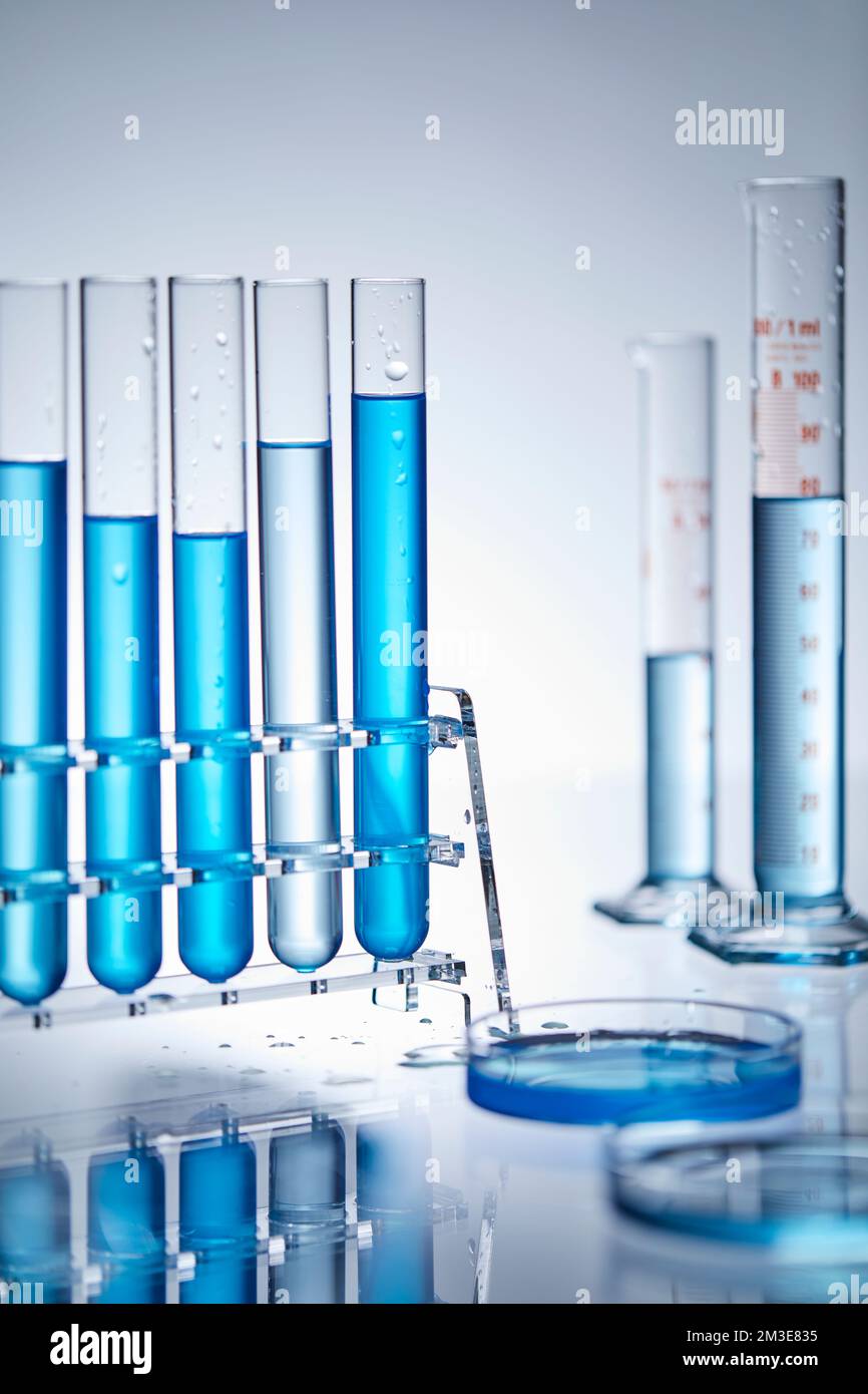 science lab with clear blue background and test tubes with blue ...