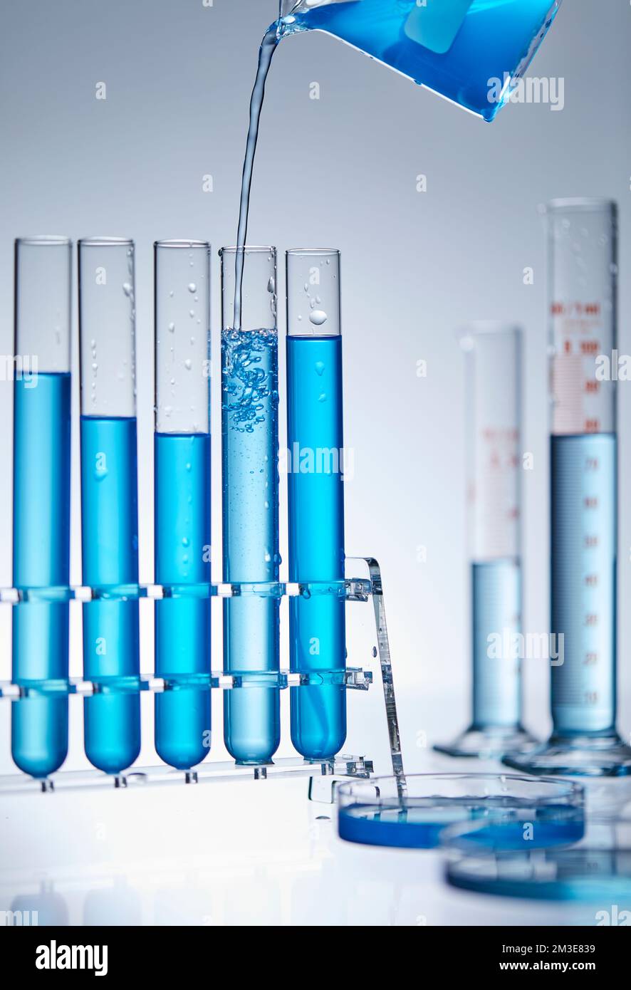 science lab with clear blue background and test tubes with blue ...