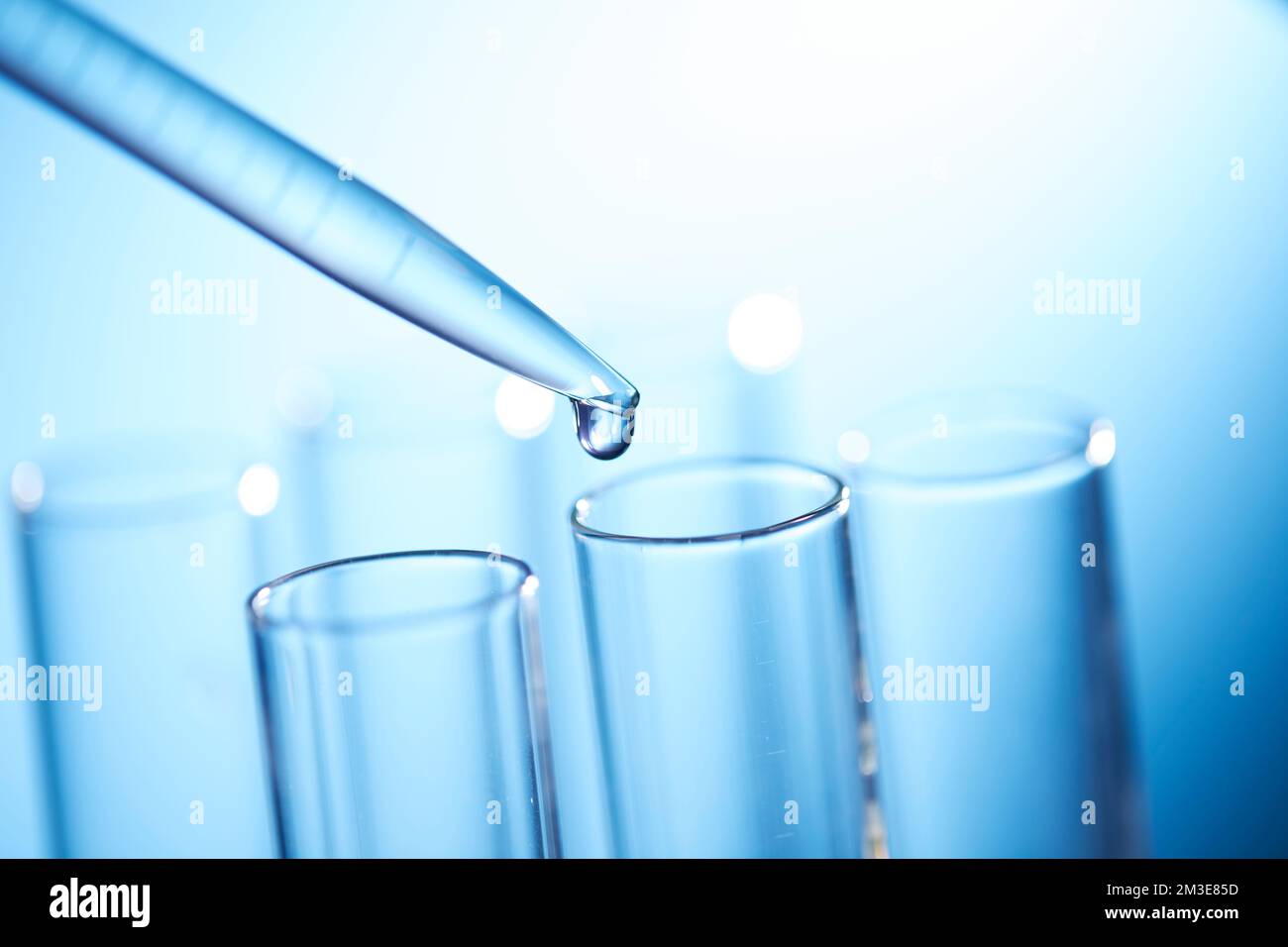 science lab with clear blue background and test tubes with blue ...