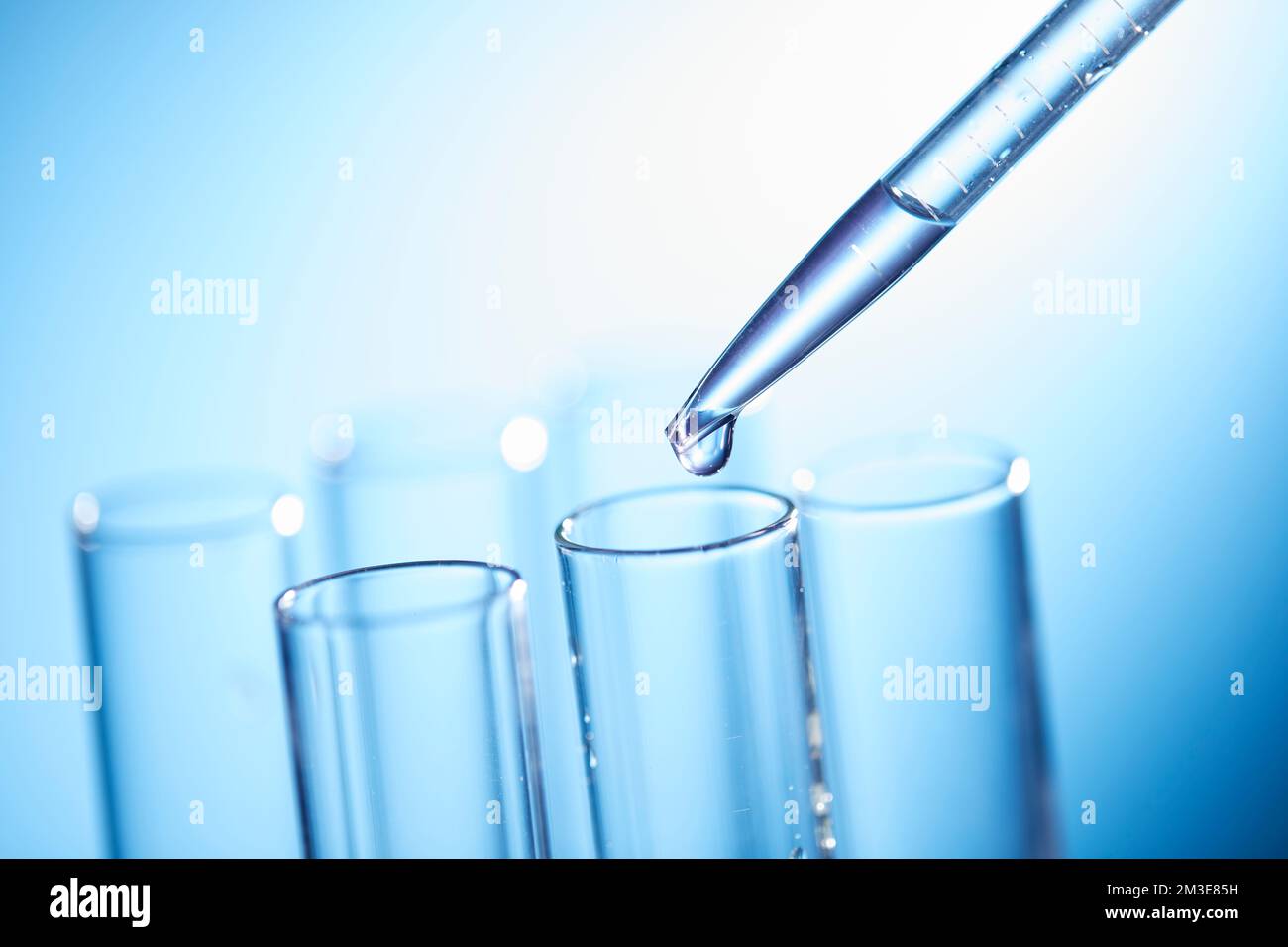 science lab with clear blue background and test tubes with blue ...