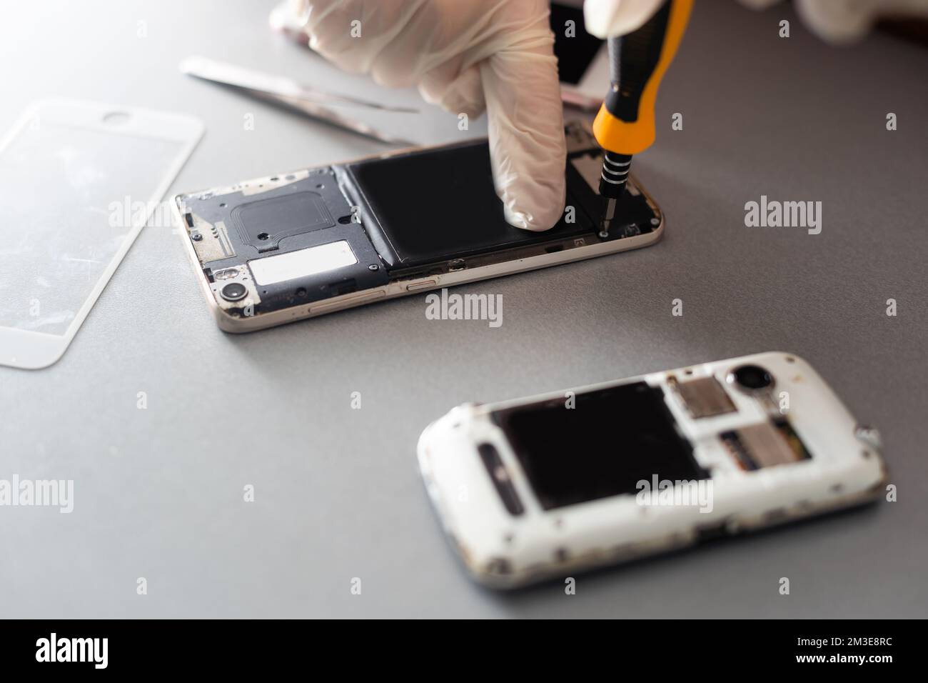 Technician repairing mobile phone at table, closeup Stock Photo - Alamy